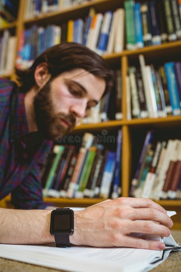 Student Studying on Floor in Library Wearing Smart Watch Stock Photo ...