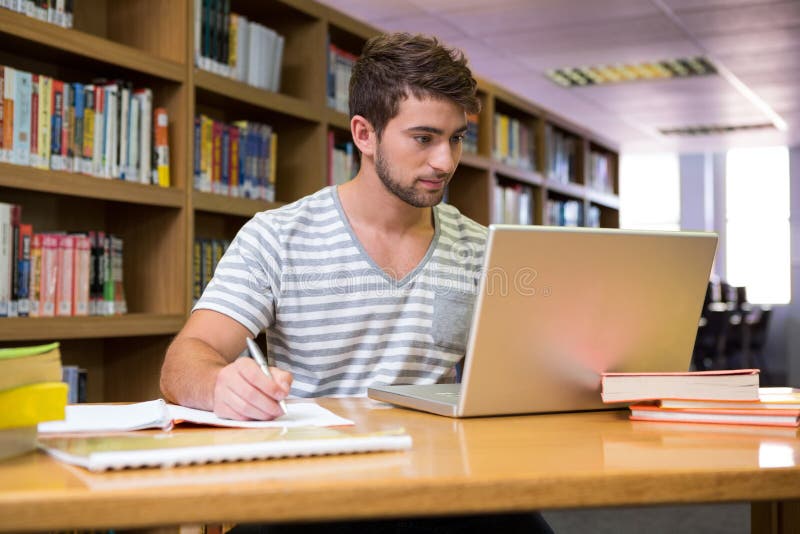Student Studying in the Library with Laptop Stock Photo - Image of ...