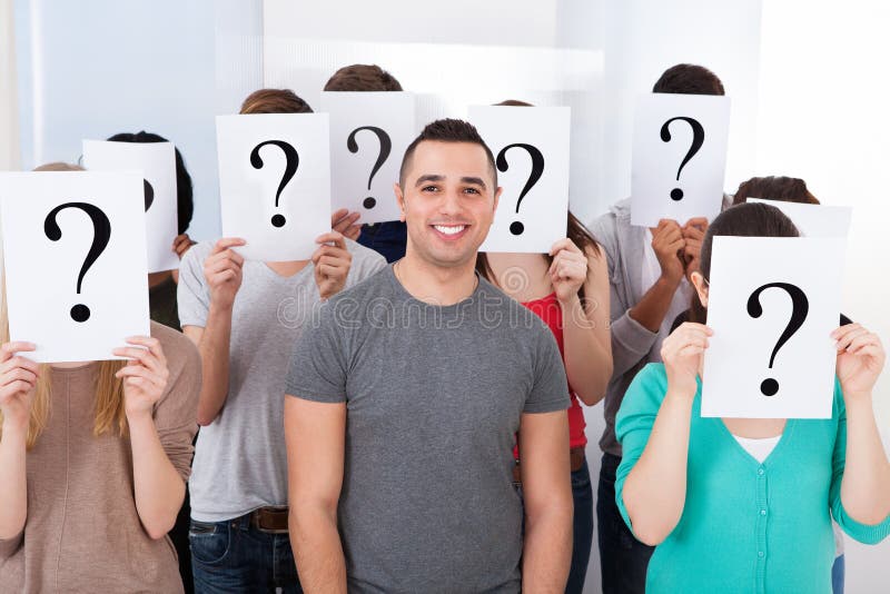 Student Surrounded by Classmates Holding Question Mark Signs Stock ...