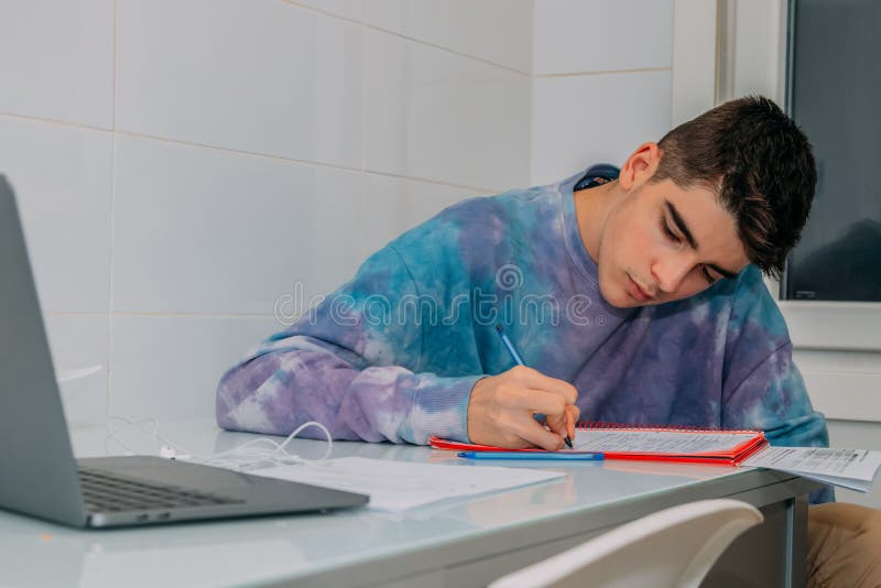Student at the Table Writing Stock Photo - Image of righthanded ...