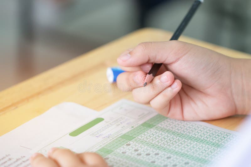 Student Taking Exams, Writing Examination on Paper Answer Sheet Optical ...