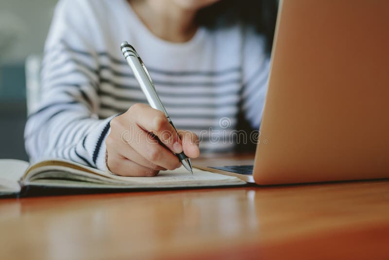 Student Taking Notes with Laptop on Table Stock Photo - Image of hand ...
