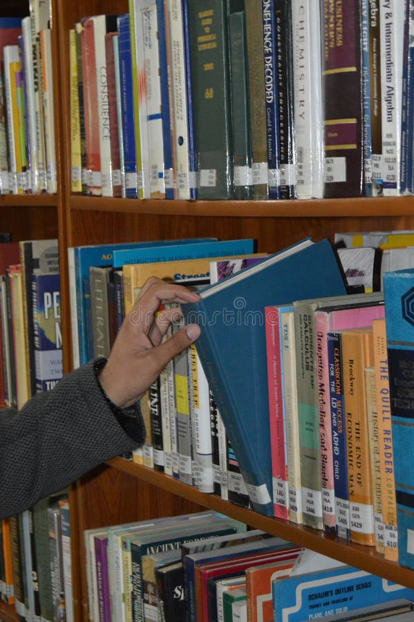 Student Taking Out Book from Shelf in Library Editorial Image - Image ...