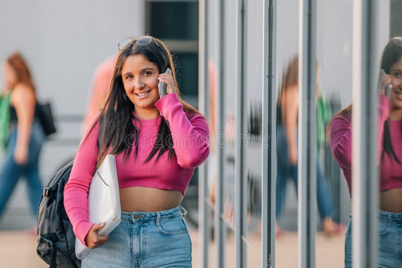 Student Using Mobile Phone Walking with Books Stock Image - Image of ...