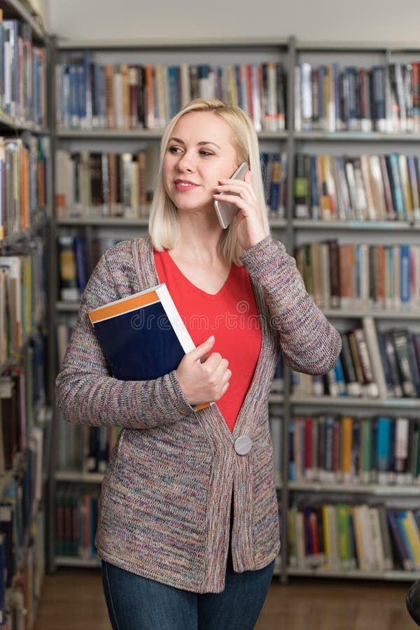 Student Talking on the Phone in Library Stock Image - Image of happy ...