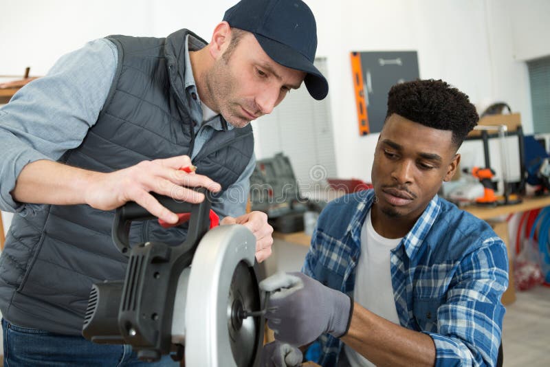 Student and Teacher in Carpentry Class Using Circular Saw Stock Photo ...