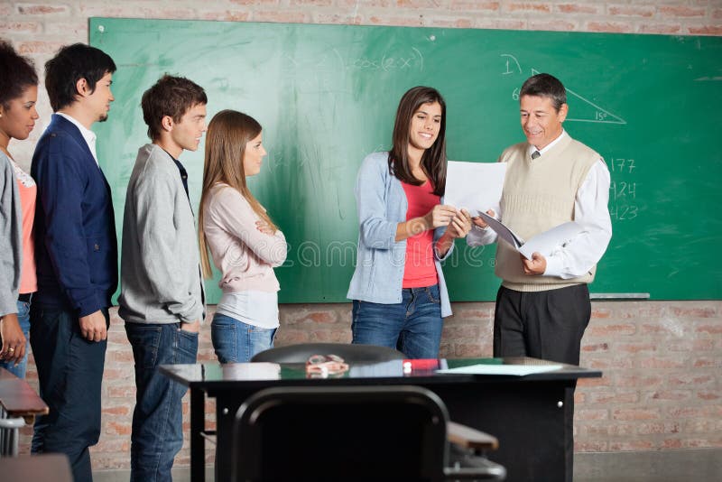 Student and Teacher Looking at Test Result in Stock Photo - Image of ...
