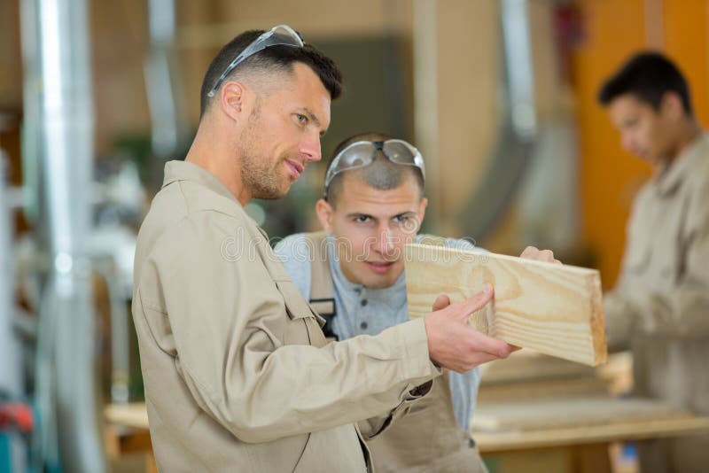 Student and Teacher Looking at Wood in Carpentry Class Stock Image ...
