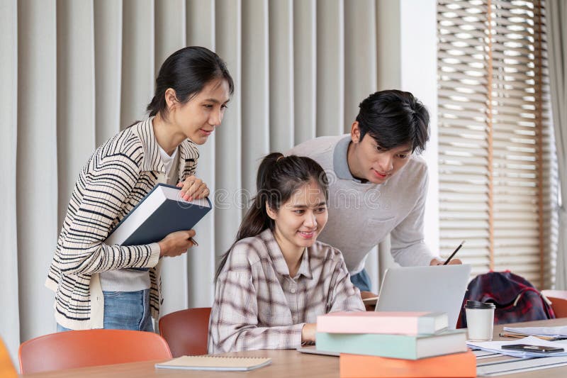 Student Team Reviewing Notes and Utilizing Technology Stock Image ...