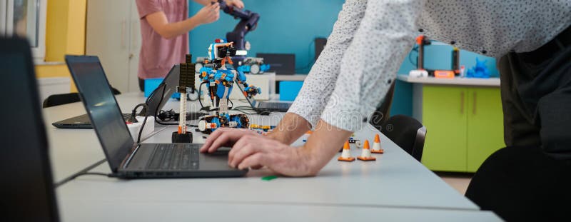 A Student Testing His New Invention of a Robotic Arm in the Laboratory ...