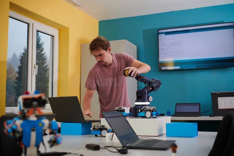 A Student Testing His New Invention of a Robotic Arm in the Laboratory ...