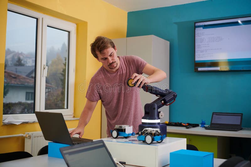 A Student Testing His New Invention of a Robotic Arm in the Laboratory ...