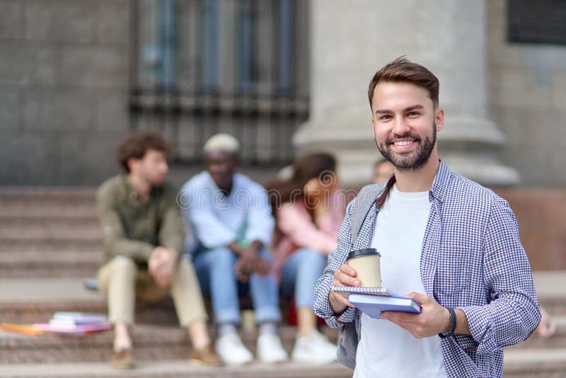 Student with Textbook and Takeaway Coffee Standing in Front of ...