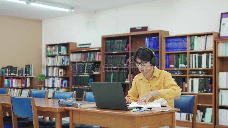 Student, Thinking and Man in Library, Laptop and Typing with Education ...