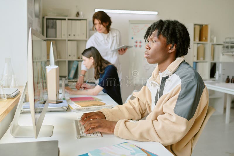 Student Typing on Computer in Modern Office Setting Stock Photo - Image ...