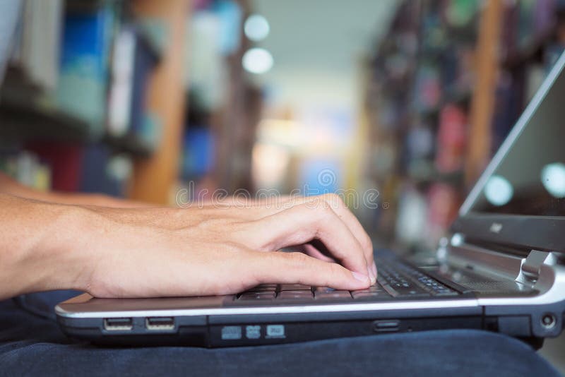 Student Use Computer Laptop for Search Data. Student Sitting in Library ...