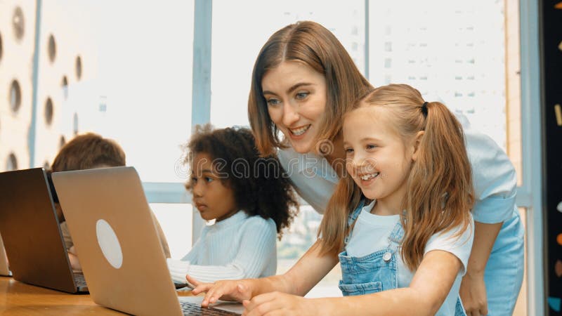 Student Use Laptop Writing Code while Teacher Explain about Program ...