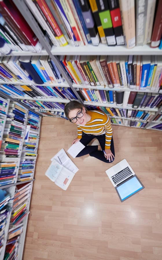 The Student Uses a Notebook and a School Library Stock Photo - Image of ...