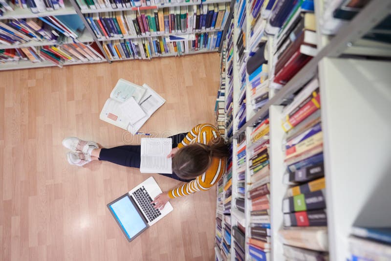 The Student Uses a Notebook and a School Library Stock Photo - Image of ...