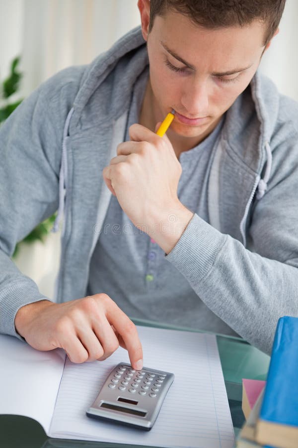 Student using a calculator stock photo. Image of living - 25334826