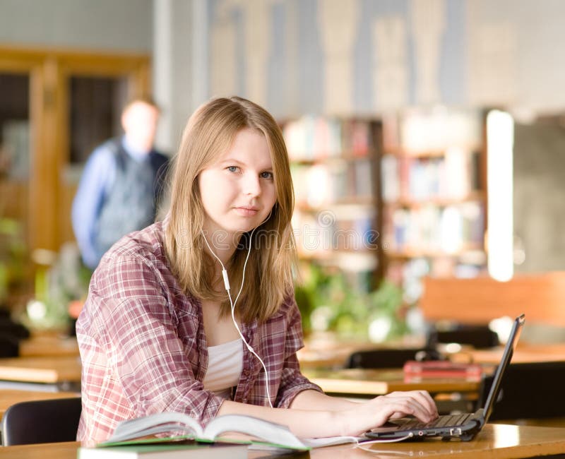 Young Student Using Computer in a Library. Stock Image - Image of book ...