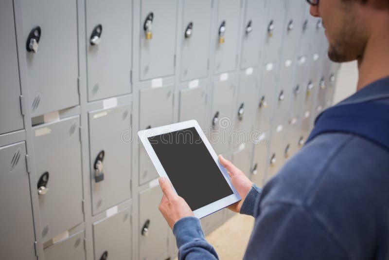 Student Using Digital Tablet in Locker Room Stock Photo - Image of ...