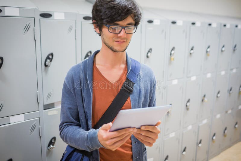 Student Using Digital Tablet in Locker Room Stock Photo - Image of ...
