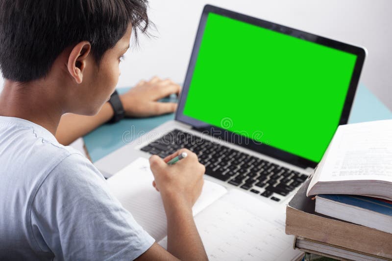 Slim Smart Boy Looking at Green Screen and Writing, Focus on Green ...