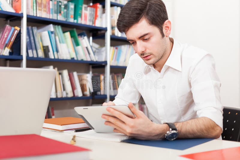 Professor Sitting at Desk Using Digital Tablet Stock Image - Image of ...