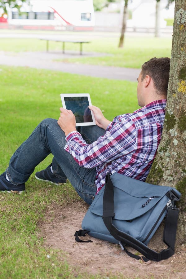Student Using His Tablet Pc Outside Leaning on Tree Stock Image - Image ...