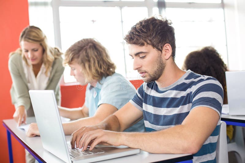 Student Using Laptop in Classroom Stock Photo - Image of mixedrace ...