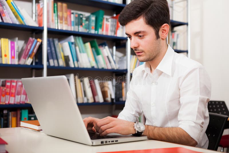 Male Student with Laptop Studying in the University Library Stock Photo ...