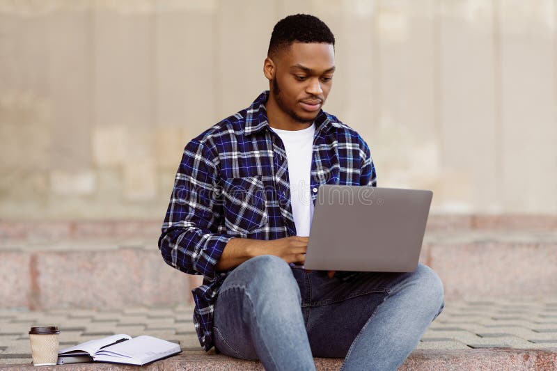 Student Using Laptop, Sitting on the Border in City Stock Photo - Image ...
