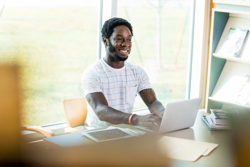 Student Using Laptop while Studying in Library Stock Photo - Image of ...