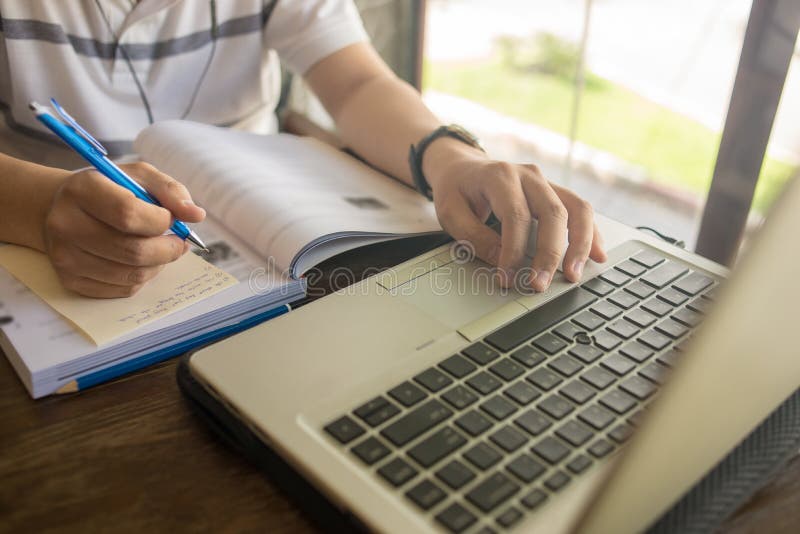 Human Hand Using Laptop and Writing Note on Wooden Table Stock Photo ...