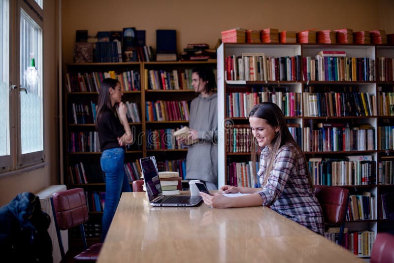 Student Using Mobile Phone in Library Stock Image - Image of adults ...