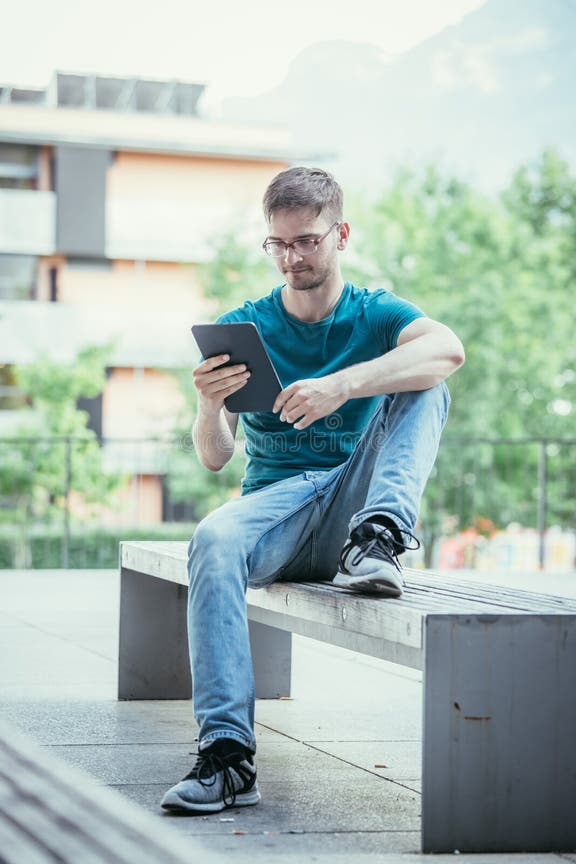 Student Using a Tablet Pc on the Campus. Outdoors, Urban Feeling ...