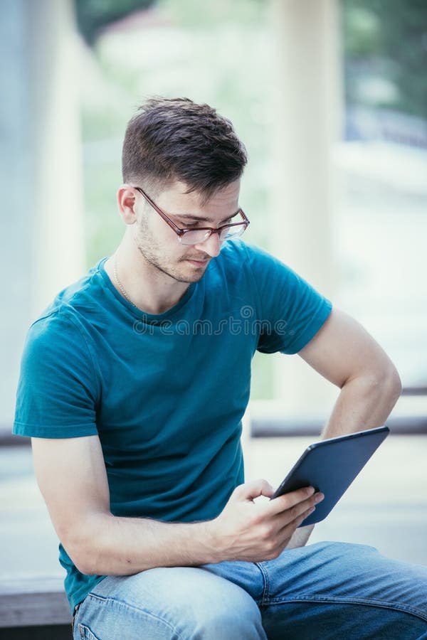 Student Using a Tablet Pc on the Campus. Outdoors, Urban Feeling ...