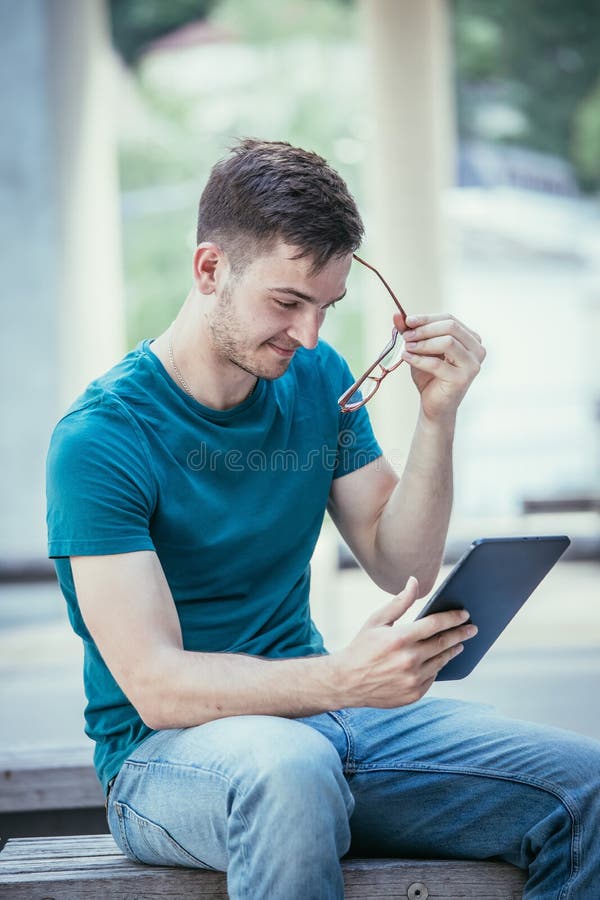Student Using a Tablet Pc on the Campus. Outdoors, Urban Feeling ...
