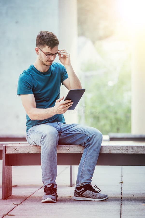 Student Using a Tablet Pc on the Campus. Outdoors, Urban Feeling ...
