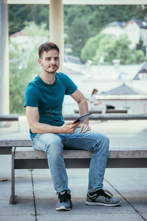 Student Using a Tablet Pc on the Campus. Outdoors, Urban Feeling ...