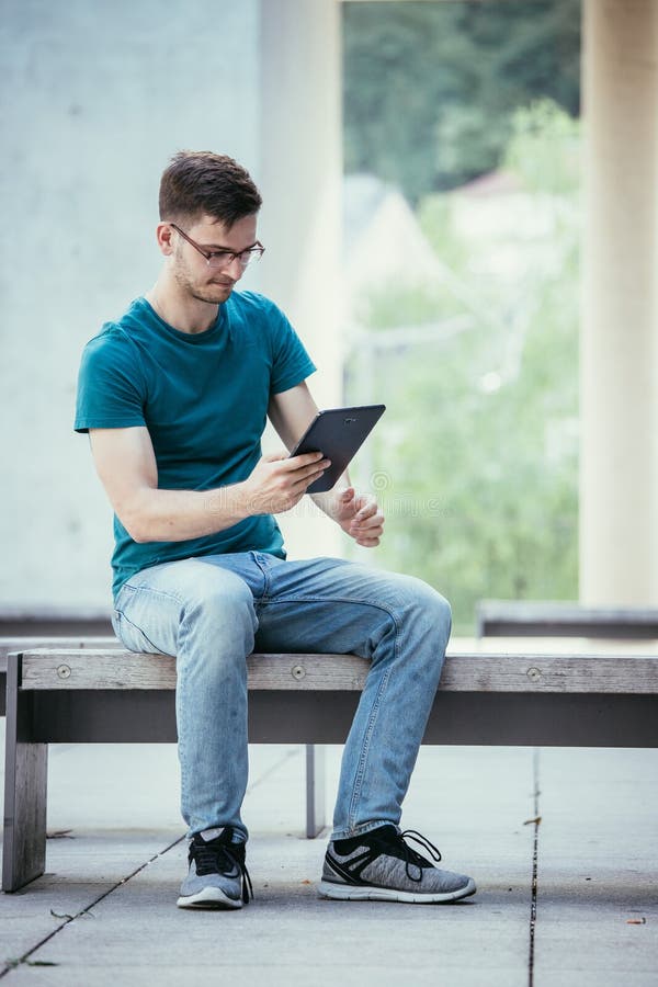 Student Using a Tablet Pc on the Campus. Outdoors, Urban Feeling ...