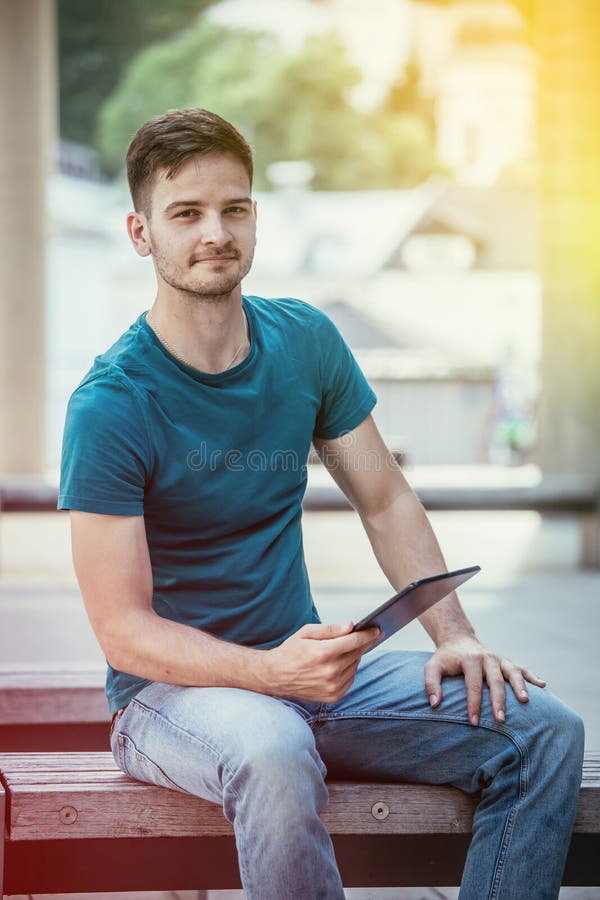 Student Using a Tablet Pc on the Campus. Outdoors, Urban Feeling ...