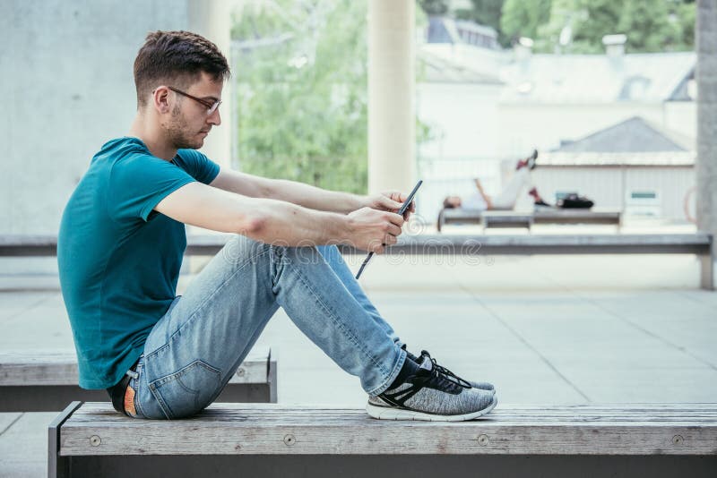 Student Using a Tablet Pc on the Campus. Outdoors, Urban Feeling ...