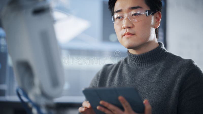 Student Using Tablet To Controll Robotic Hand. Bionic Arm Moving in ...