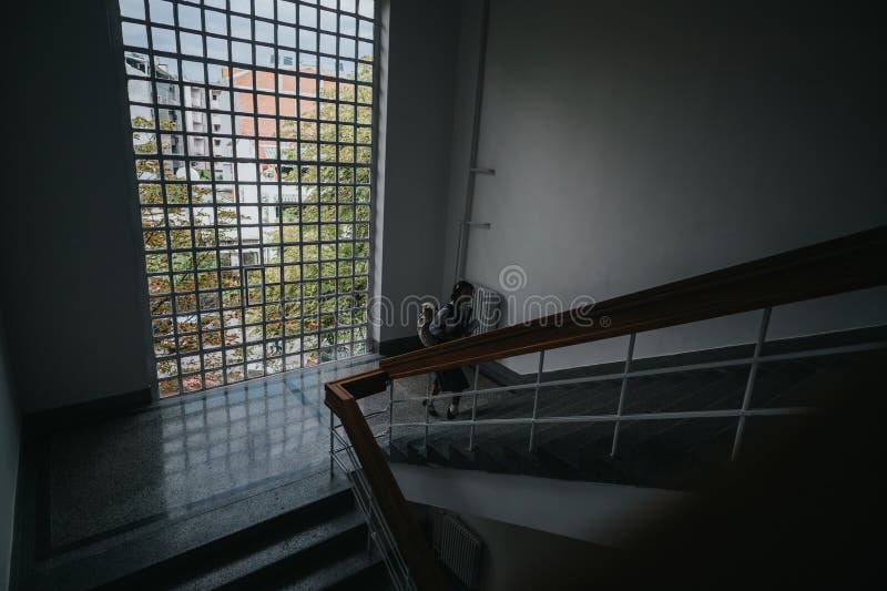 Student Walking Up Staircase in Modern Building with Large Window Stock ...