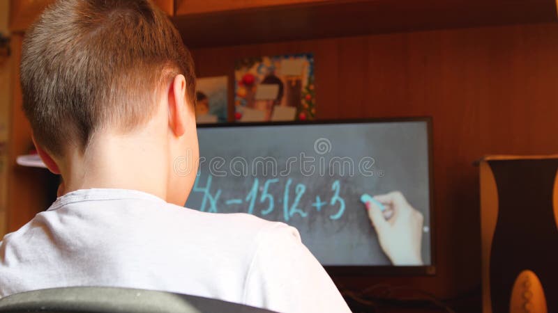 The Student Watches the Lesson Online and Learns at Home. a Young Guy ...
