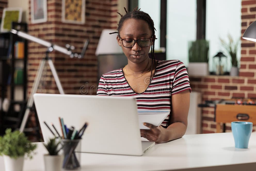 Student Watching Educational Video Tutorial on Laptop, Taking Notes ...