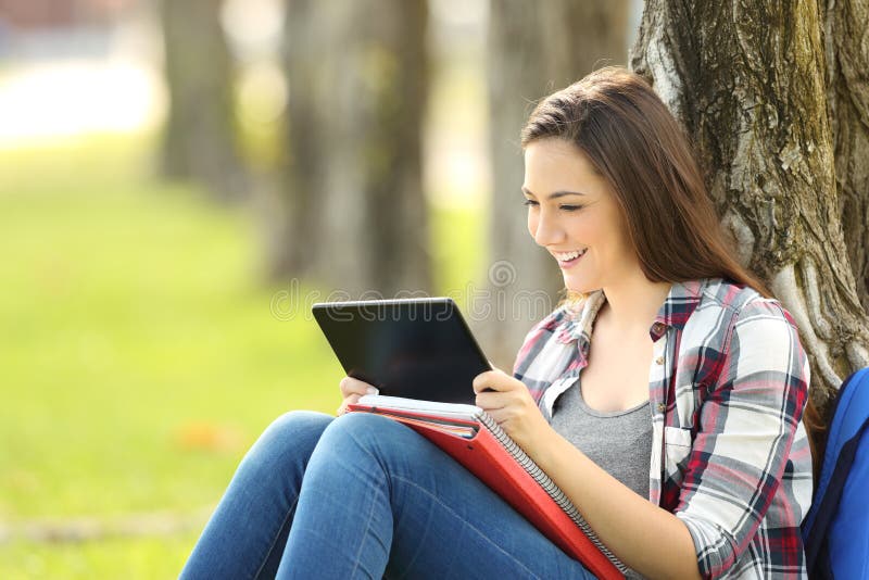 Student Watching Media Content in a Tablet Stock Image - Image of book ...