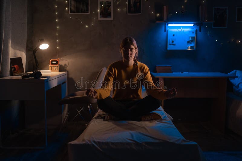 Student Woman Practicing Meditation on the Bed in Dormitory at Night ...